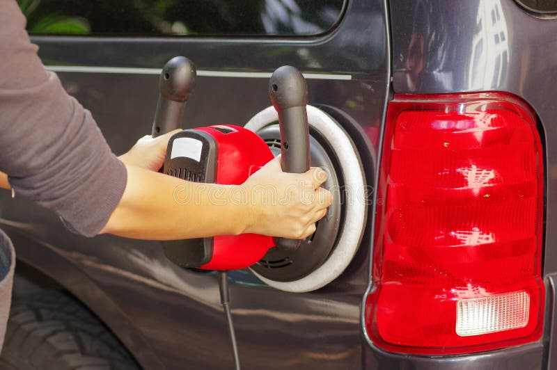 Man with a Power Buffer Machine Cleaning the Back Part of a Car Stock ...