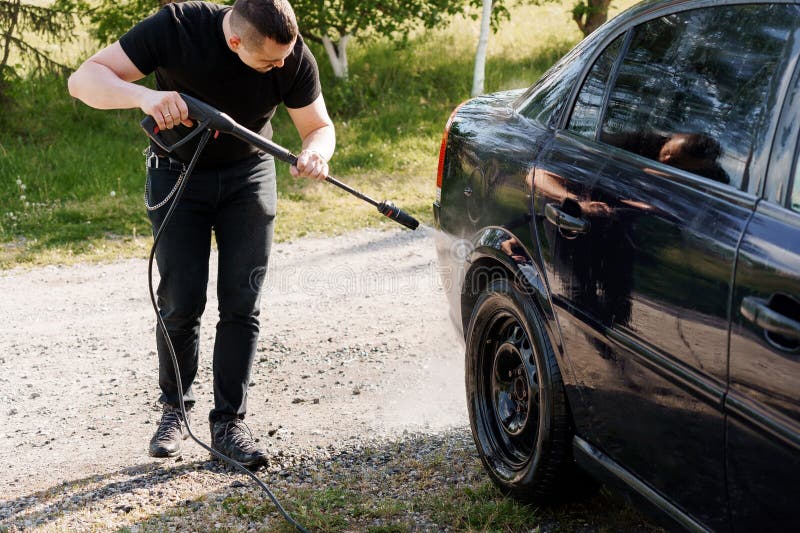 A Man Power Washing a Car on a Sunny Day Stock Photo - Image of ...