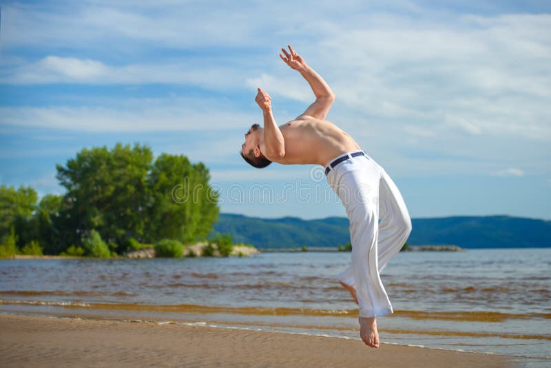 The Man is a Coach of Capoeira and a Boy Practicing Capoeira on the ...