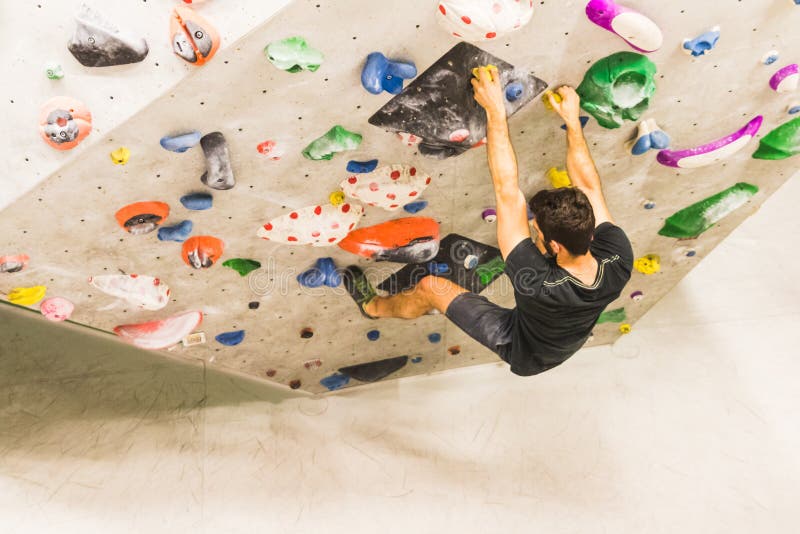 Man Practicing Rock Climbing on Artificial Wall Indoors. Active ...