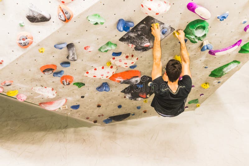 Man Practicing Rock Climbing on Artificial Wall Indoors. Active ...