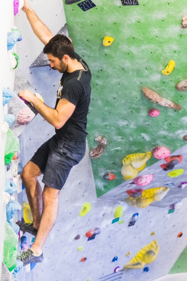 Man Practicing Rock Climbing on Artificial Wall Indoors. Active ...