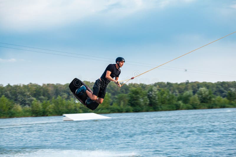 Man Practicing Technique of Jumping Over Water during Wakeboarding ...