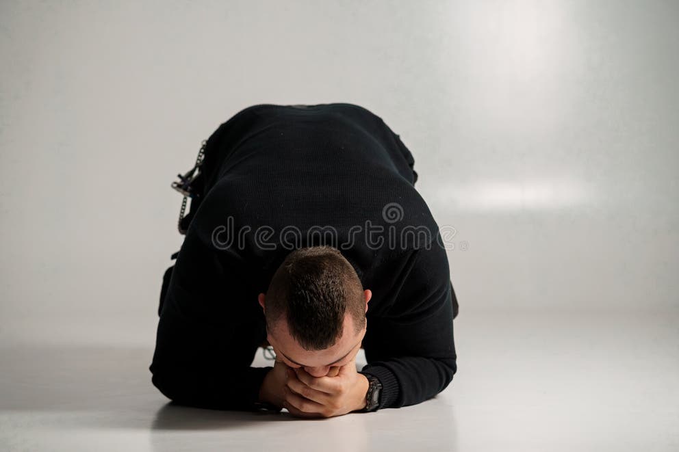 Man in Prayer Pose Reflecting Emotional Distress and Vulnerability ...