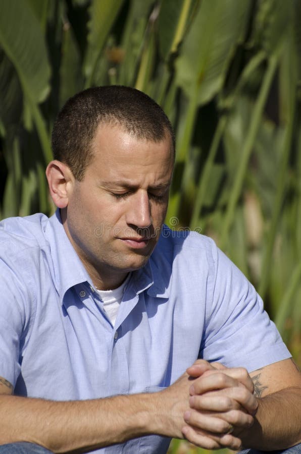 Man praying outside. stock photo. Image of pondering - 74749498