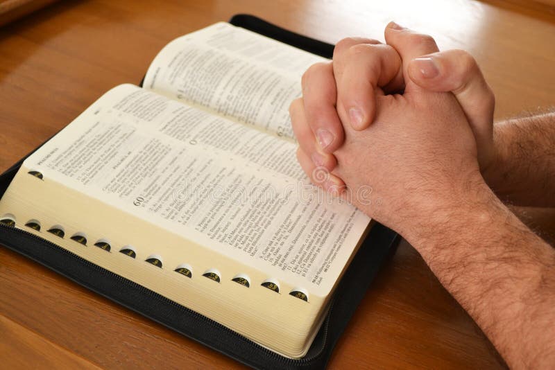 Man praying over a Bible stock image. Image of church - 28638939