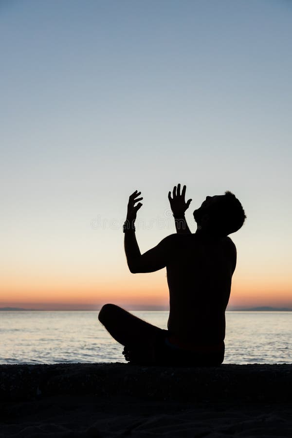 Man Praying To God on the Beach in Sunset Stock Image - Image of ...
