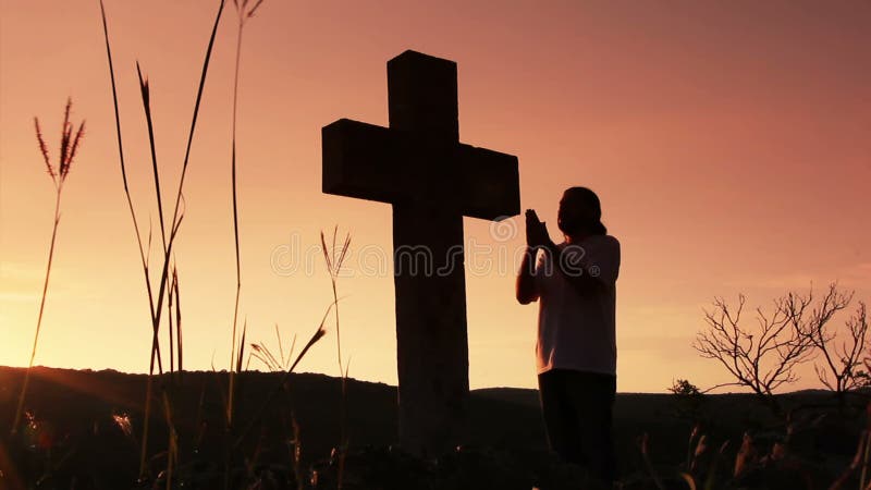 Man Praying Under the Cross Stock Footage - Video of catholic, dawn ...