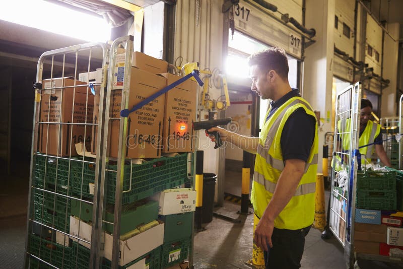 Man Prepares and Scans Packages in a Warehouse for Delivery Stock Image ...