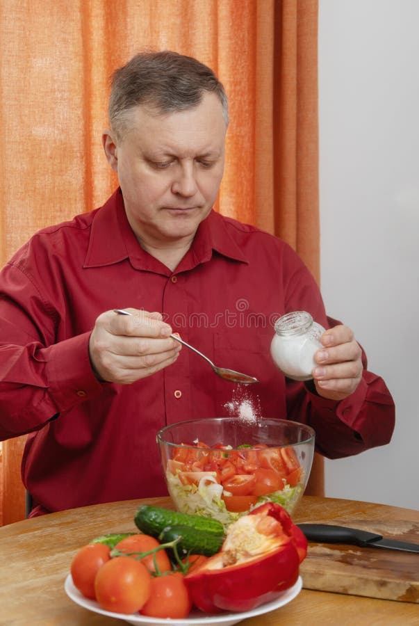 A Man Prepares a Vegetable Salad in His Kitchen Stock Photo - Image of ...