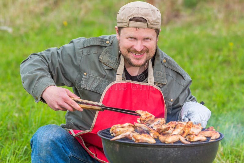 Man preparing barbecue stock photo. Image of delicious - 59922380