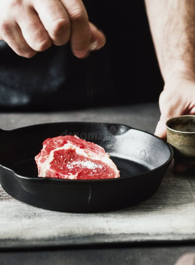 Man Preparing Beef Steak on Wooden Table Stock Image - Image of food ...
