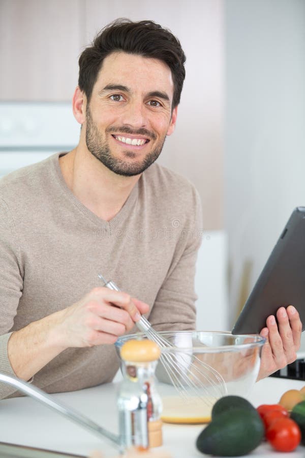 Man Preparing Cake Mixture while Using Tablet Stock Image - Image of ...