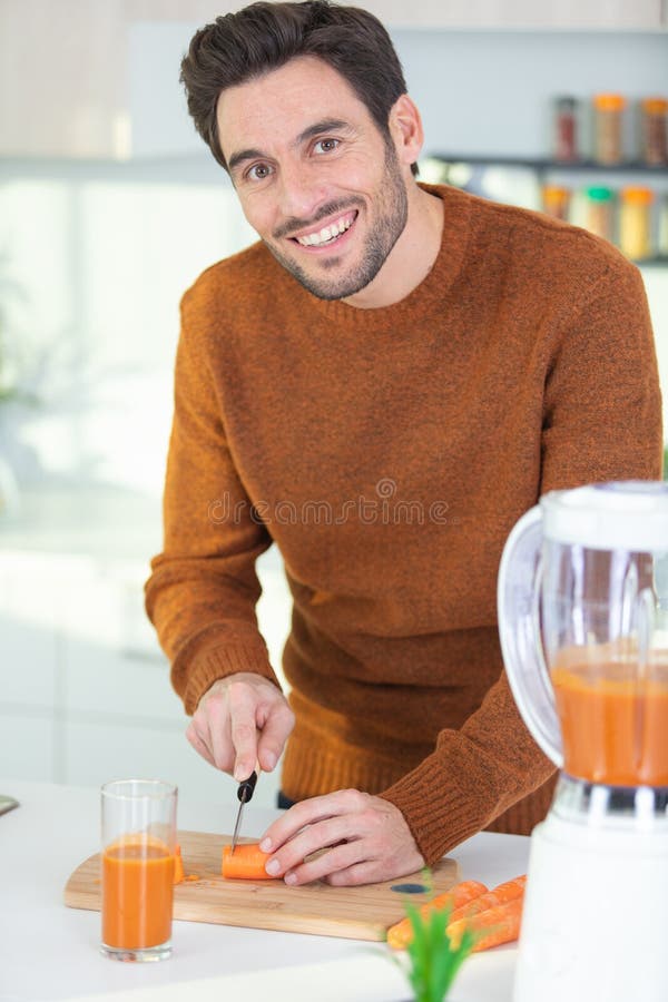 Man Preparing Carrots for Blending for Juice Stock Image - Image of ...