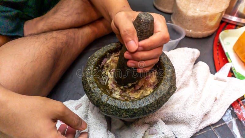 Man Preparing a Cooking Ingredients by Using Mortar and Pestle at the ...