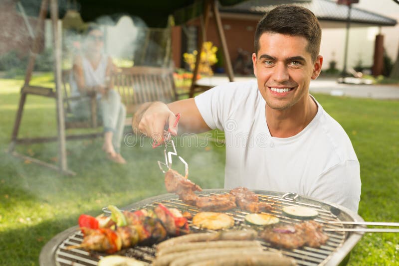 Man preparing dinner stock photo. Image of picnic, handsome - 71327522