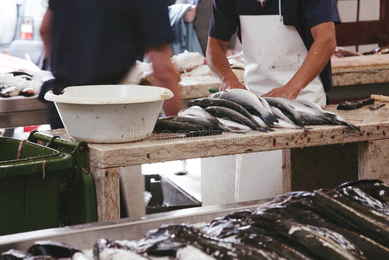 Man preparing fish stock image. Image of food, cropped - 100348075