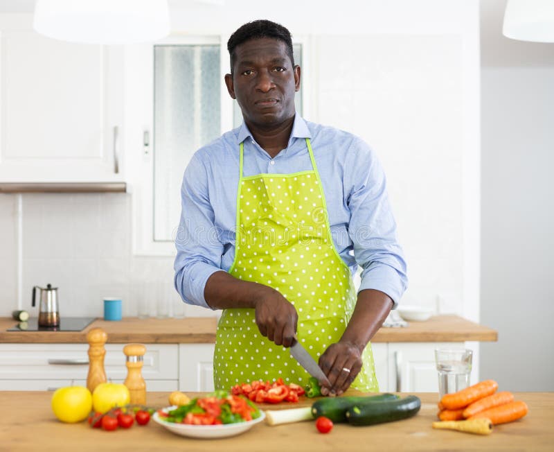 Man preparing food at home stock photo. Image of cooking - 267286098