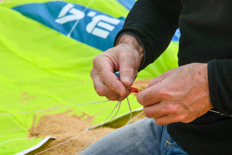 A Man is Preparing is Kite on the Beach. Stock Photo - Image of making ...