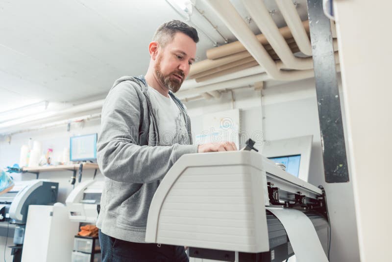 Man Preparing Large Format Printer for a Print Job Stock Image - Image ...