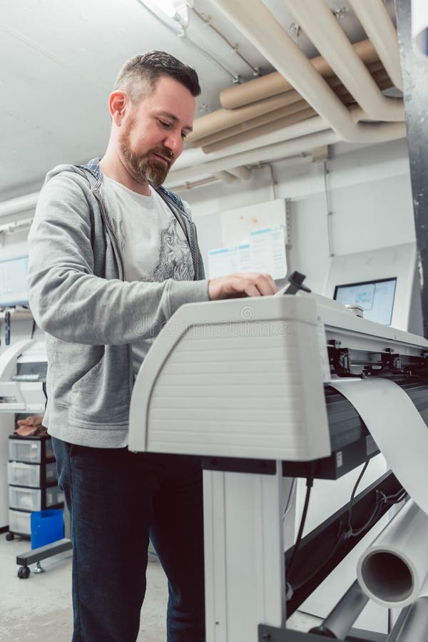 Man Preparing Large Format Printer for a Print Job Stock Photo - Image ...
