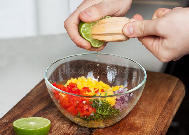 Man Preparing Mango Salsa, Squeezing Lime Juice Stock Photo - Image of ...