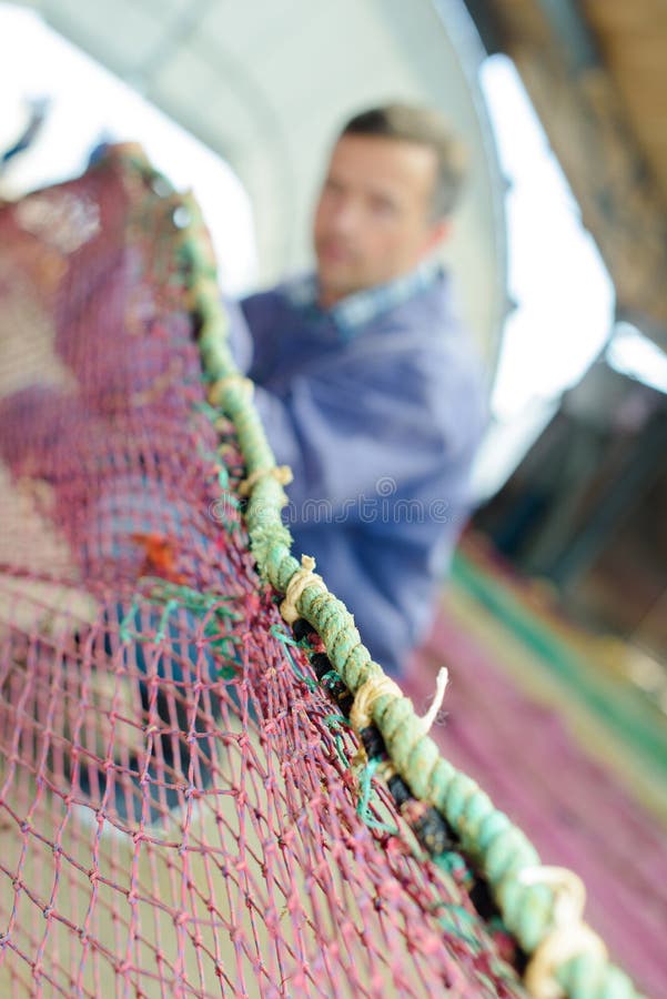 Man preparing nets stock image. Image of dock, ship - 288845899