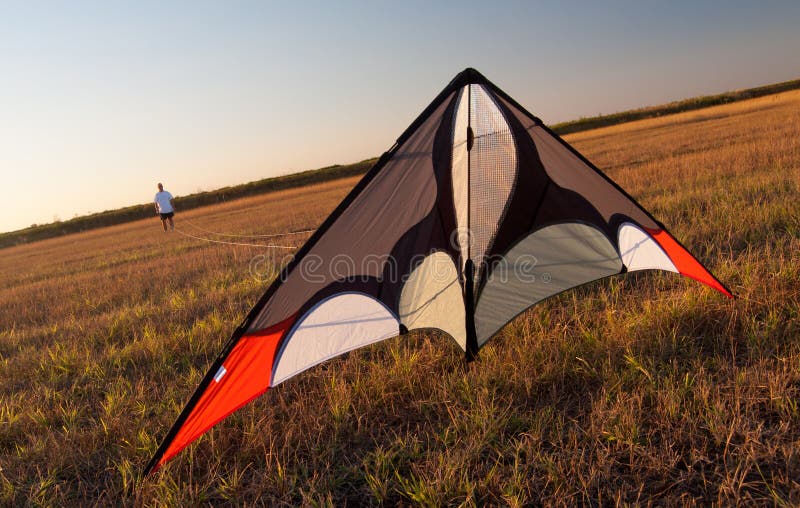 Man Preparing To Pull a Kite Up in the Air Stock Photo - Image of sunny ...
