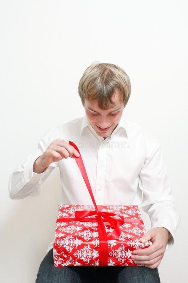 Man with present stock photo. Image of smile, sitting - 10891340