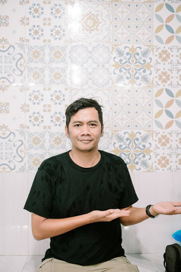 Man Presenting with Decorative Tile Background Portrait Casual Style ...