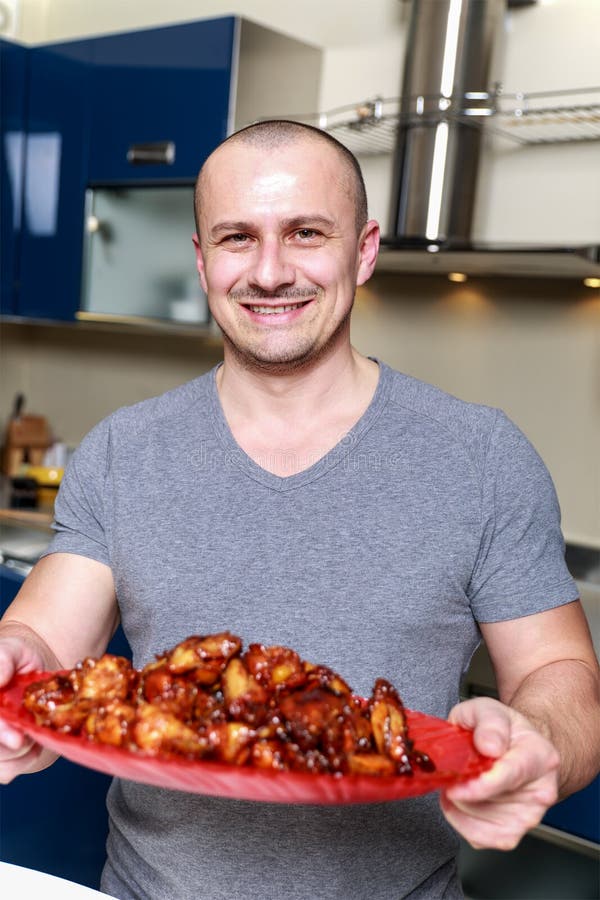 Man Presenting A Platter Of Chicken Wings Stock Image - Image of ...