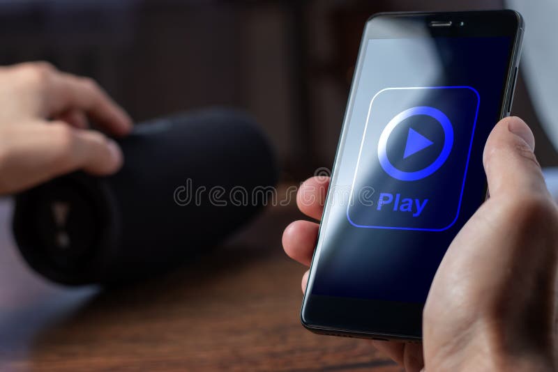 Man Press Button Play To Music on Smartphone Bluetooth Speaker Stock ...