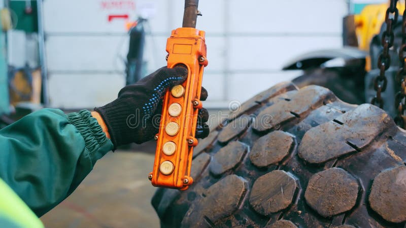A Man Presses a Button on a Control Panel in a Factory. Work in ...