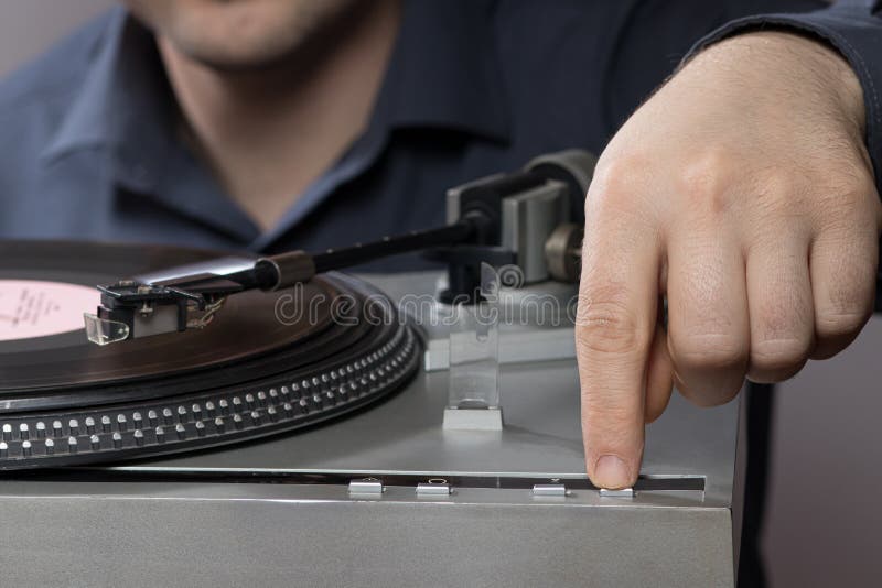 A Man Presses a Gramophone Vinyl Record Player Button. Vintage Record ...