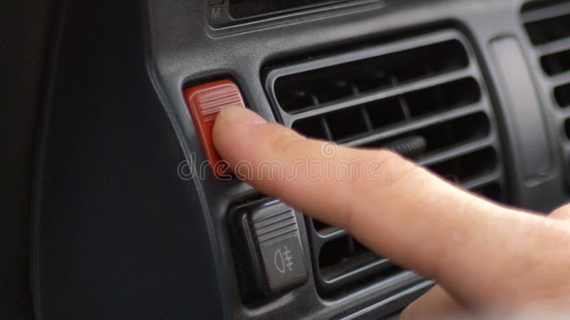 A Man Presses His Finger on the Car Emergency Lighting Button on the ...
