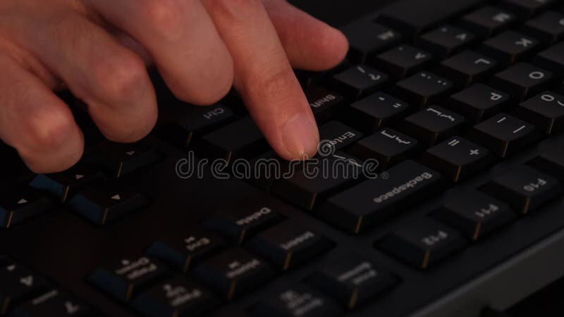 A Man Pressing the Enter Key on a Black Keyboard Multiple Times Stock ...
