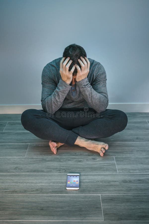Man with Problems Sitting on the Floor Behind of His Mobile Stock Image ...