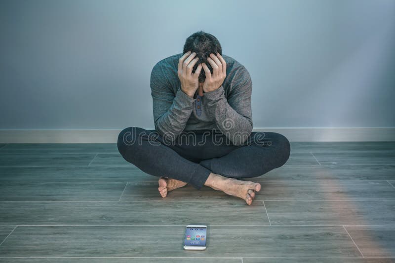 Man with Problems Sitting on the Floor Behind of His Mobile Stock Image ...