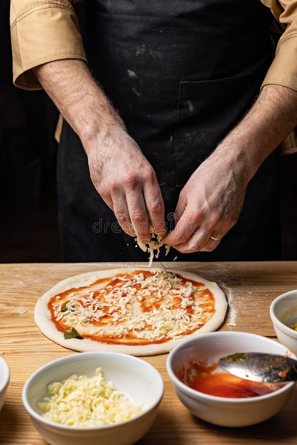Man in the Process of Making a Homemade Pizza, with a Layer of Melted ...