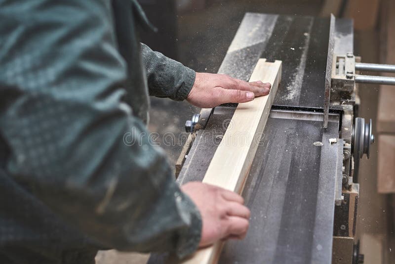 The Man Processes Bar from a Light Tree on the Jointer Plane Stock ...