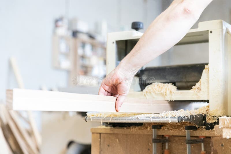 A Man is Processing a Tree. Joiner. a Carpenter. Woodworking Processes ...