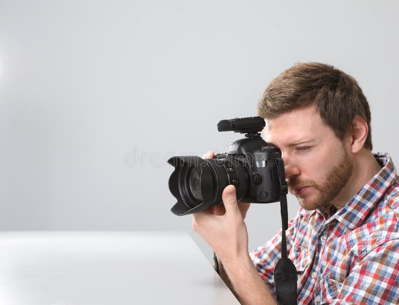 Man with Professional Camera in Photo Studio Stock Photo - Image of ...