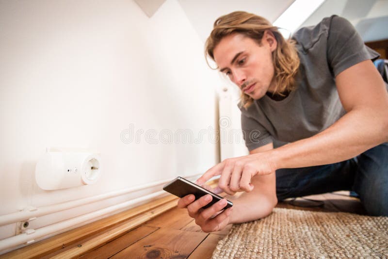 Man Programming a Power Outlet Using His Phone Stock Photo - Image of ...