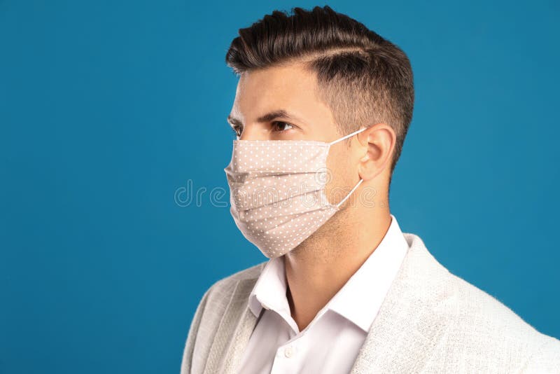 Man in Protective Face Mask on Blue Background. Space for Text Stock ...