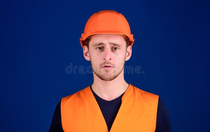 Man in Protective Helmet, Hard Hat and Working Uniform, Blue Background ...