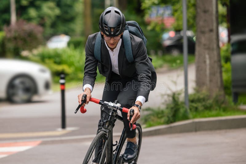 Man in Protective Hemlet Riding a Bike on the Road Stock Photo - Image ...