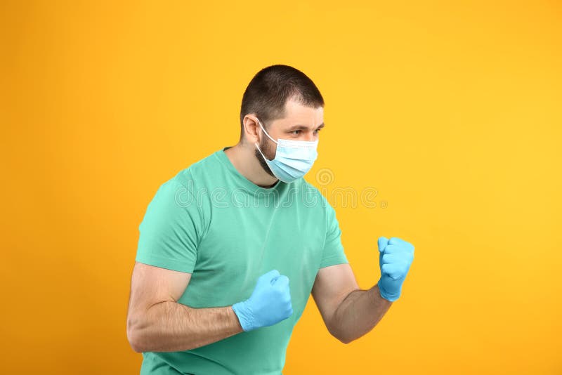 Man with Protective Mask and Gloves in Fighting Pose on Yellow ...