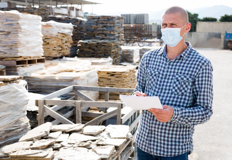 Man in Protective Mask of Hardware Store Keeps Records of Natural Stone ...