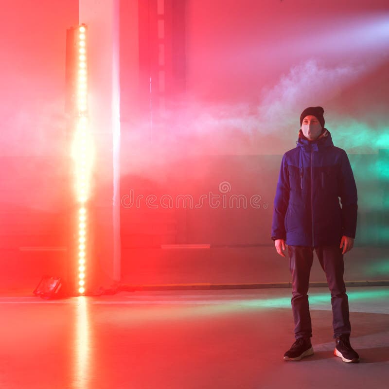 Man in Protective Mask Stand in Neon Light Garage. Stock Photo - Image ...