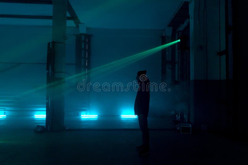 Man in Protective Mask Stand in Neon Light Garage. Stock Photo - Image ...
